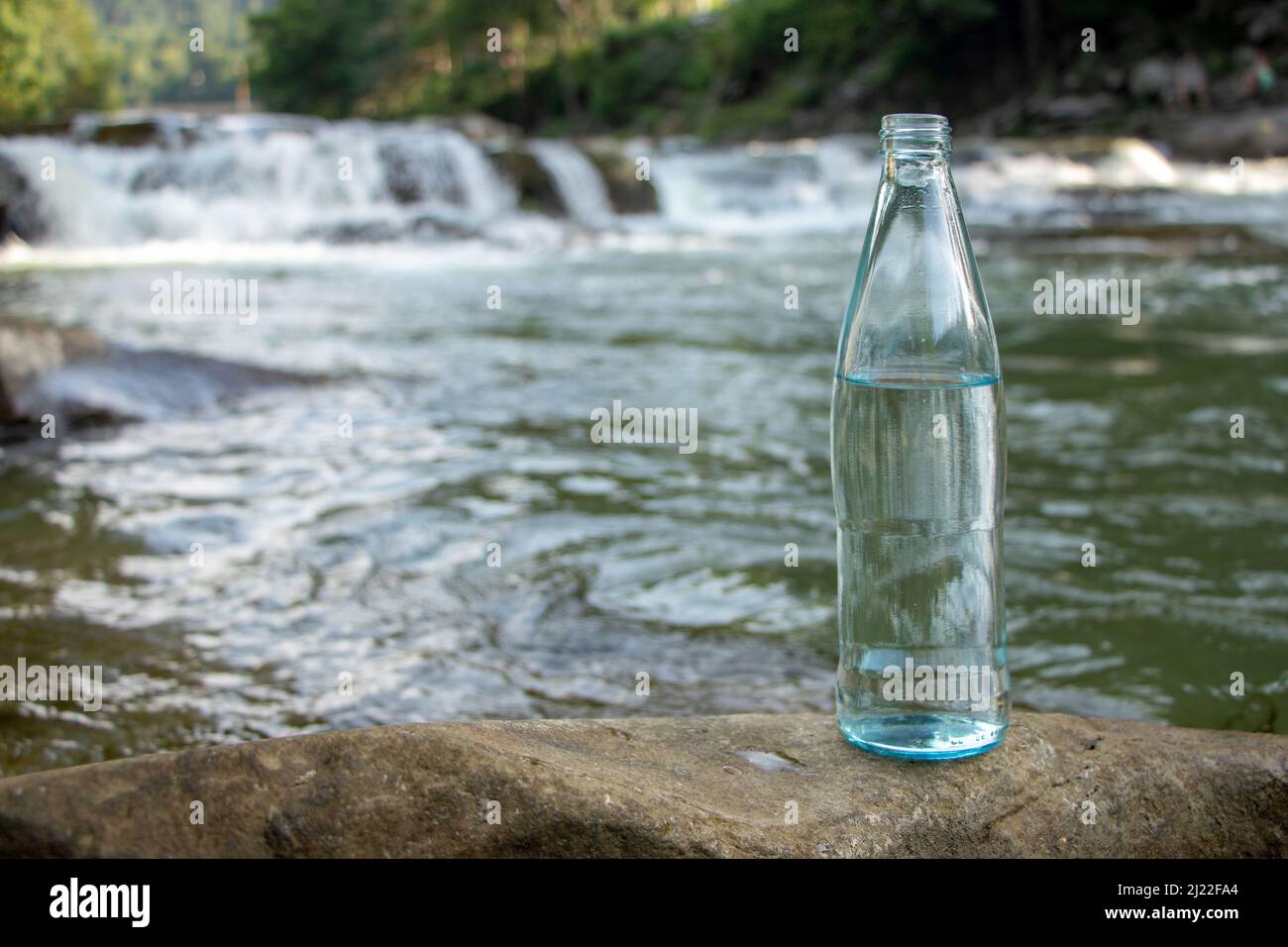 Natural drinking water in a bottle on nature background river Stock ...
