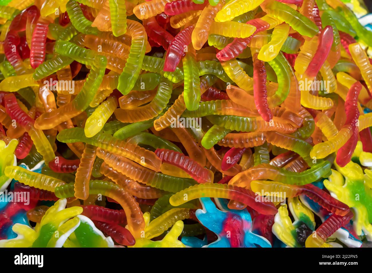 Colorful jelly candies in the form of worms. Candy background Stock ...