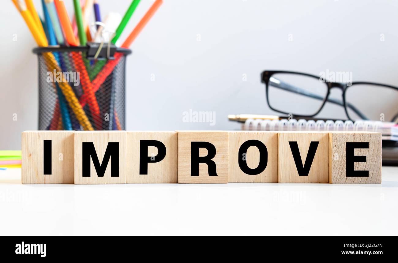 Man made word IMPROVE with wood blocks Stock Photo - Alamy
