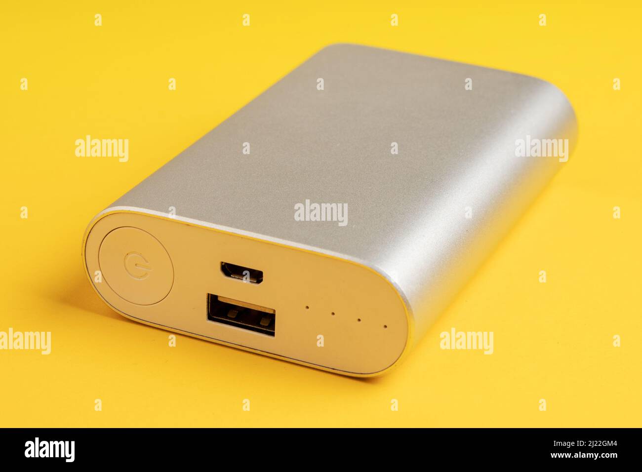 Portable power bank for charging mobile devices on yellow Stock Photo ...