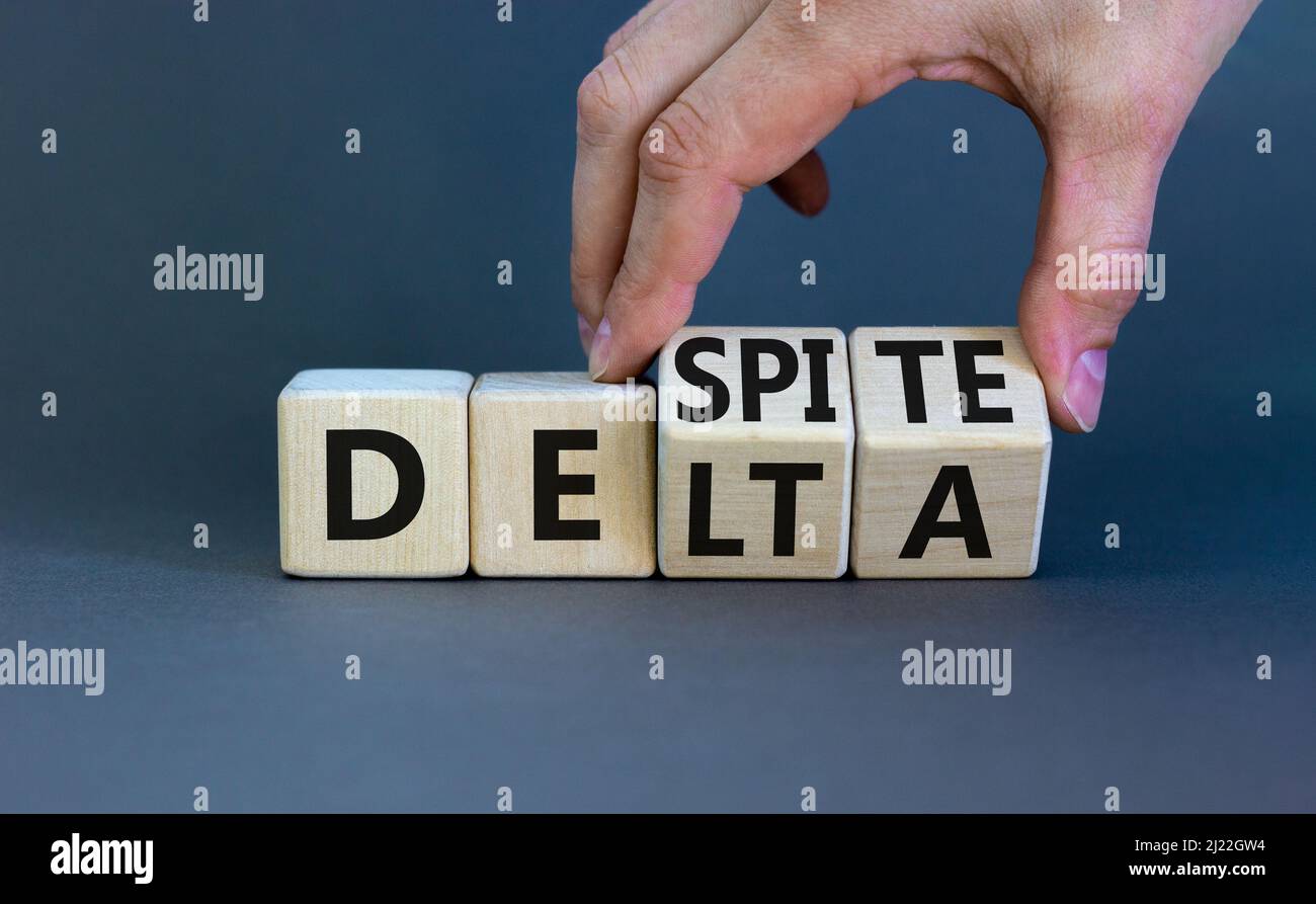 Covid-19 delta variant strain despite symbol. Doctor turns wooden cubes ...