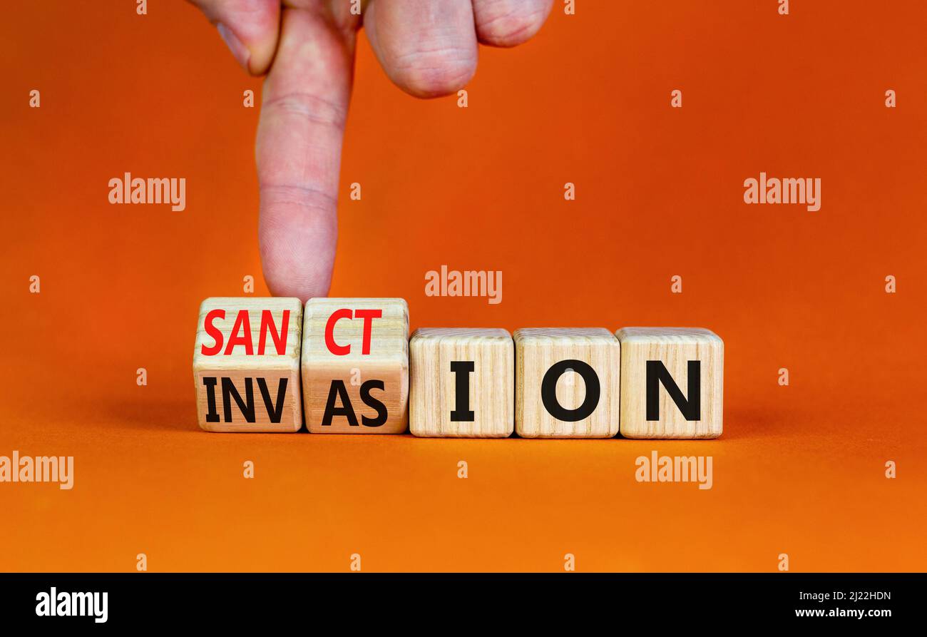 Sanction against invasion symbol. Businessman turns cubes and changes ...