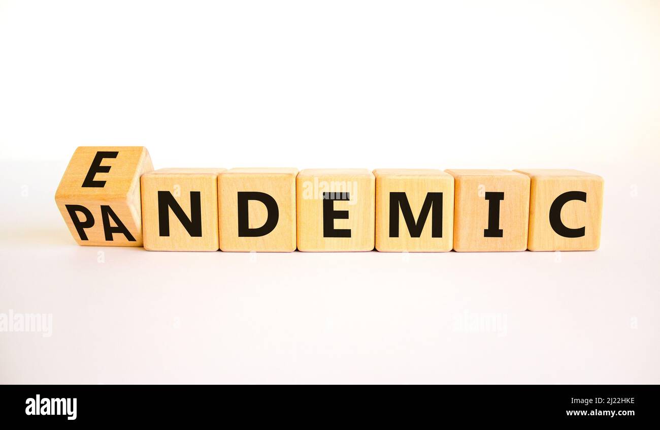Covid-19 pandemic or endemic symbol. Turned wooden cubes and changed ...