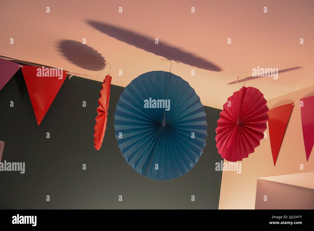 Round fan concertina paper celebration decorations Stock Photo - Alamy