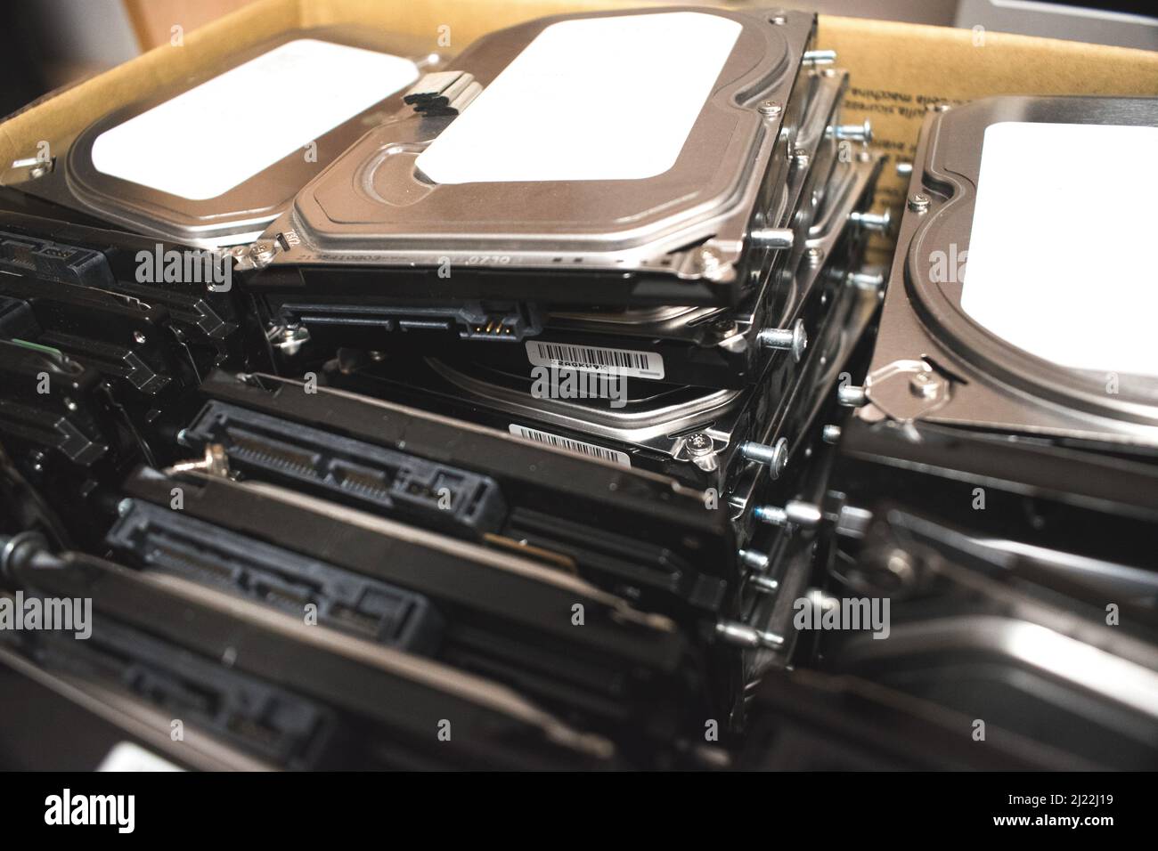 Mechanical hard drives stacked in a box for scrapping Stock Photo - Alamy