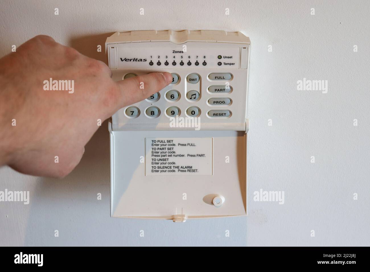 Pressing key on security pad, household alarm keypad Stock Photo - Alamy