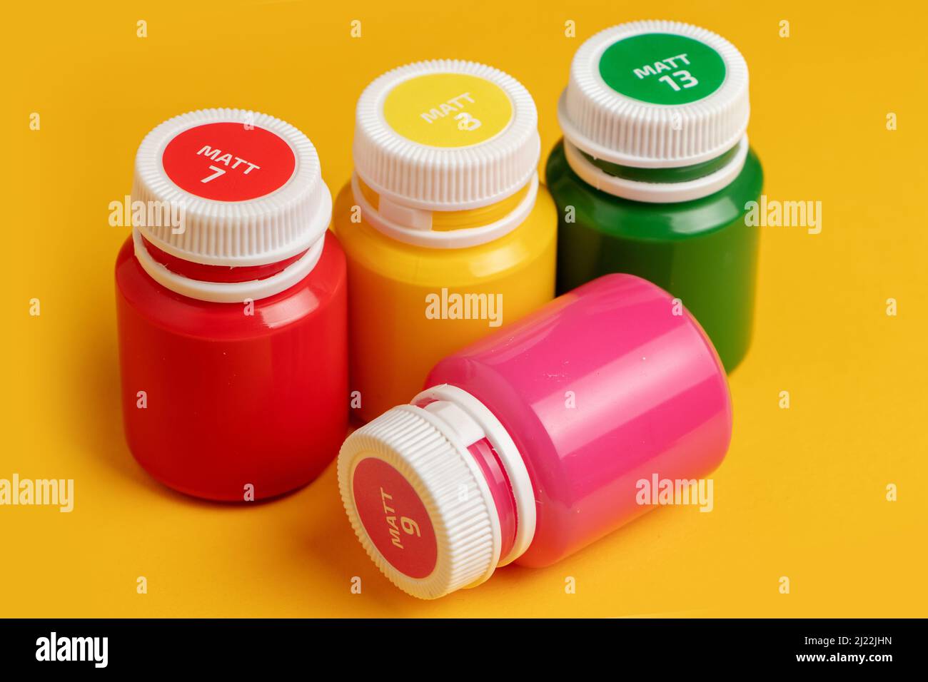Color oil paint bottles on yellow background Stock Photo - Alamy