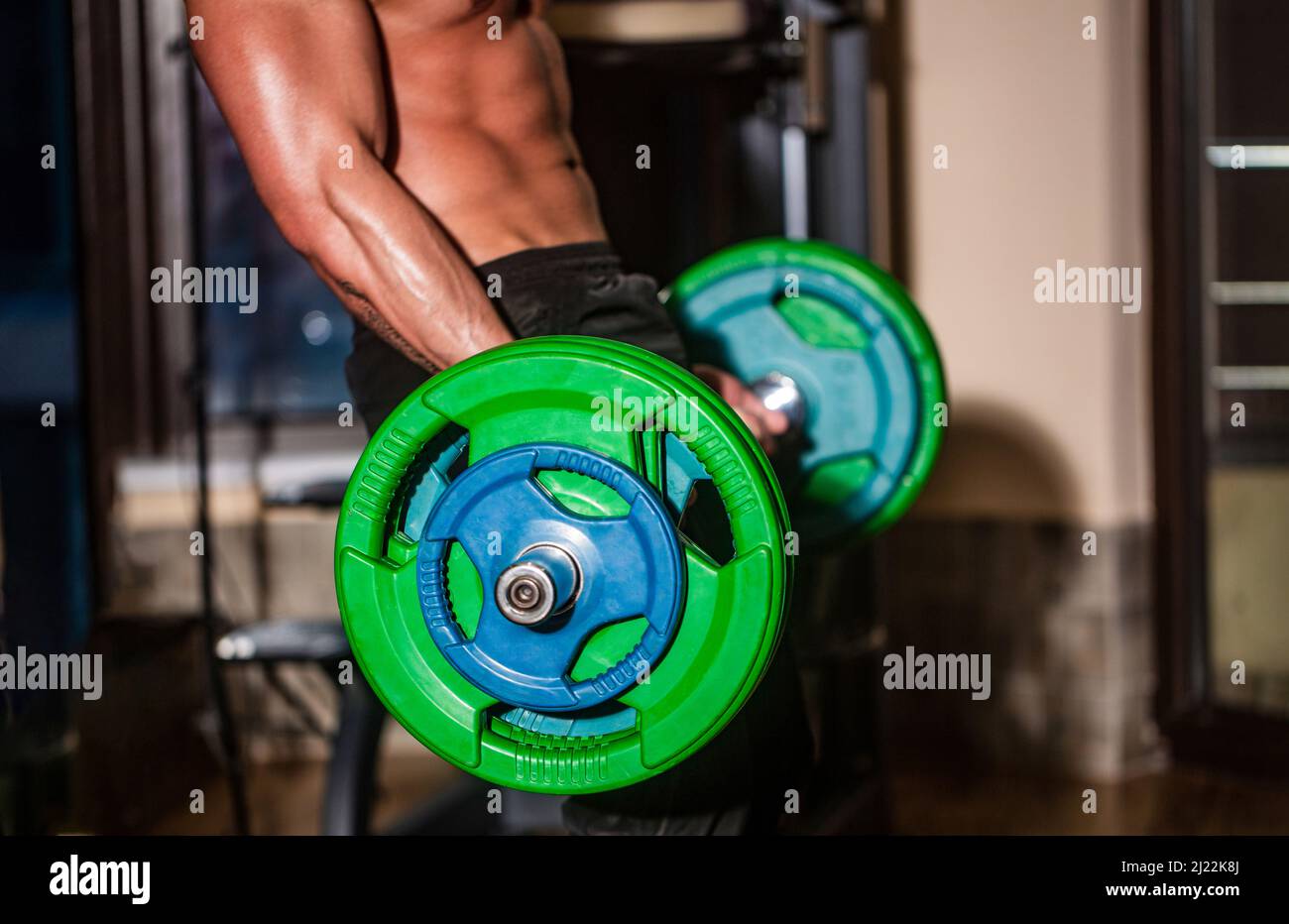 Barbells workout. Athletic guy standing with barbell, workout in gym ...