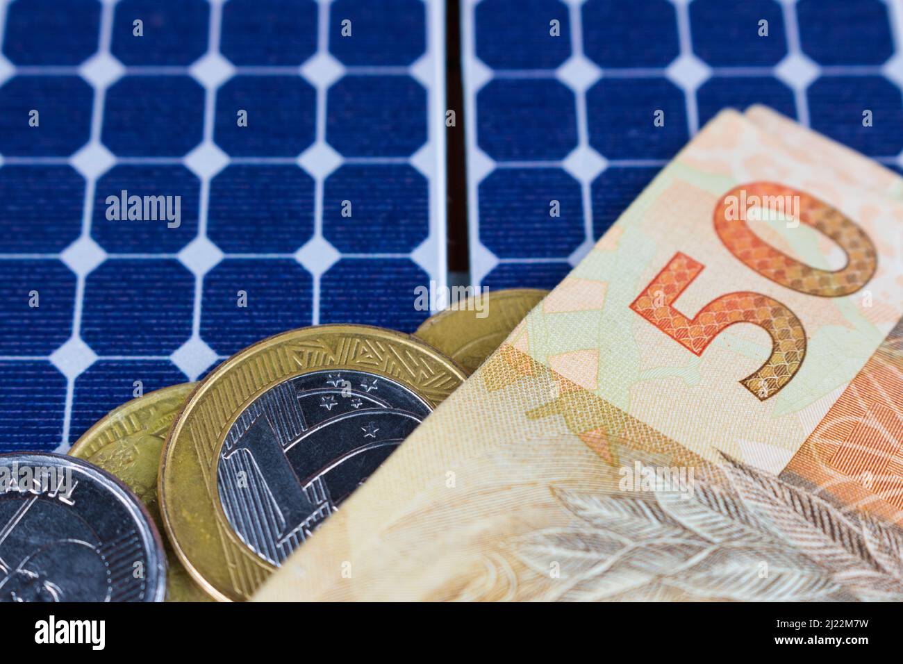 Money and photovoltaic solar energy panel. Brazilian. Brazilian ...