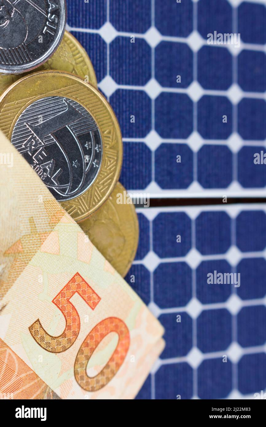 Money and photovoltaic solar energy panel. Brazilian. Brazilian ...