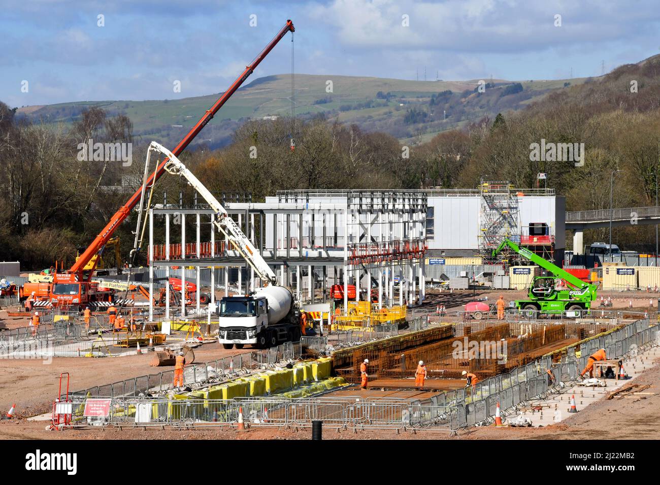 Taffs Well, Wales - March 2022: Construction workers and machinery ... Taffs Well, Wales - March 2022: Construction workers and machinery ...