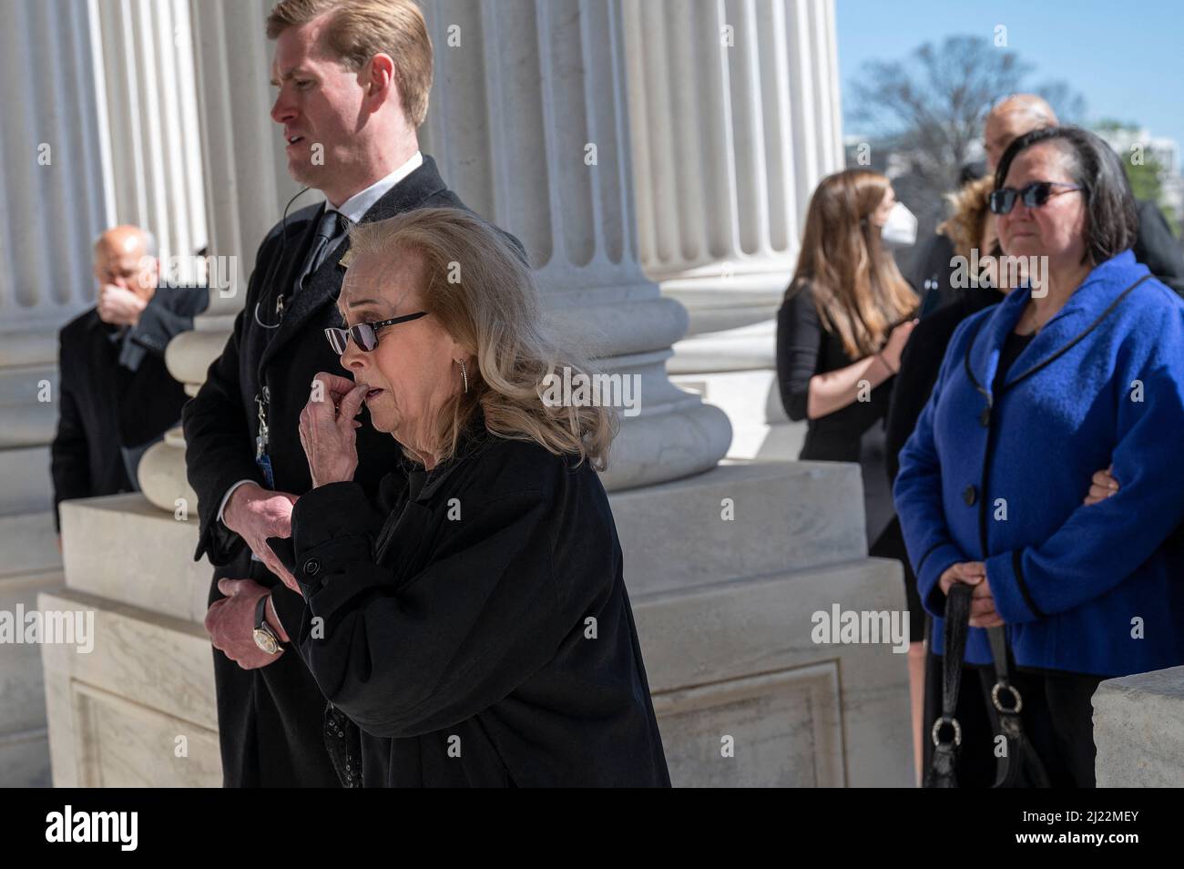 Washington, D.C., 29 March 2022. Widow Anne Young (C) is escorted ...