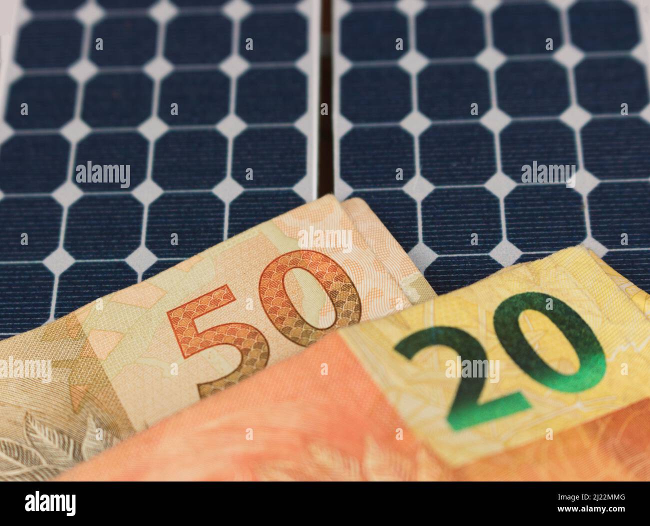 Money and photovoltaic solar energy panel. Brazilian. Brazilian ...