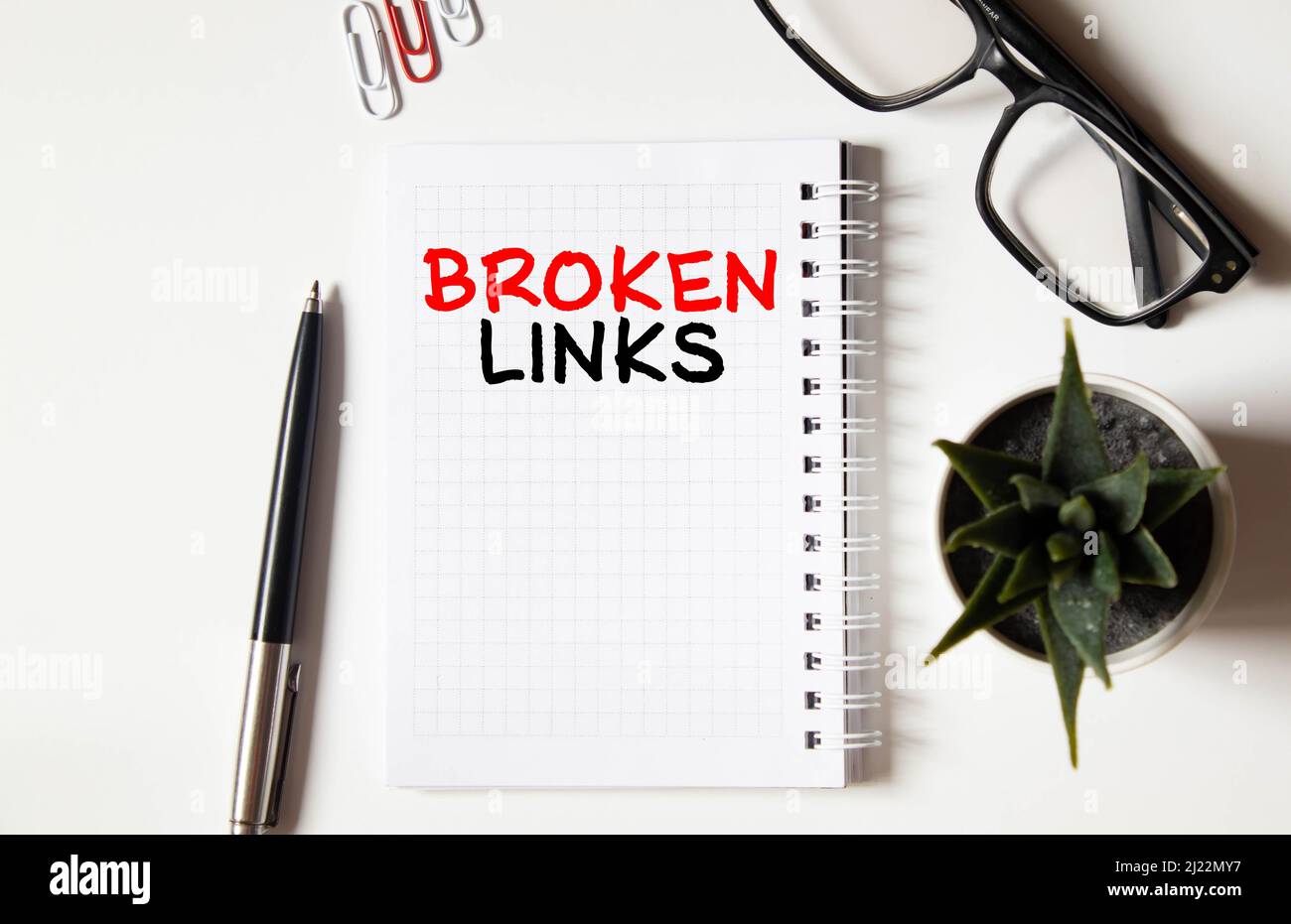 Broken links - text on yellow note sheets on a dark wooden background ...