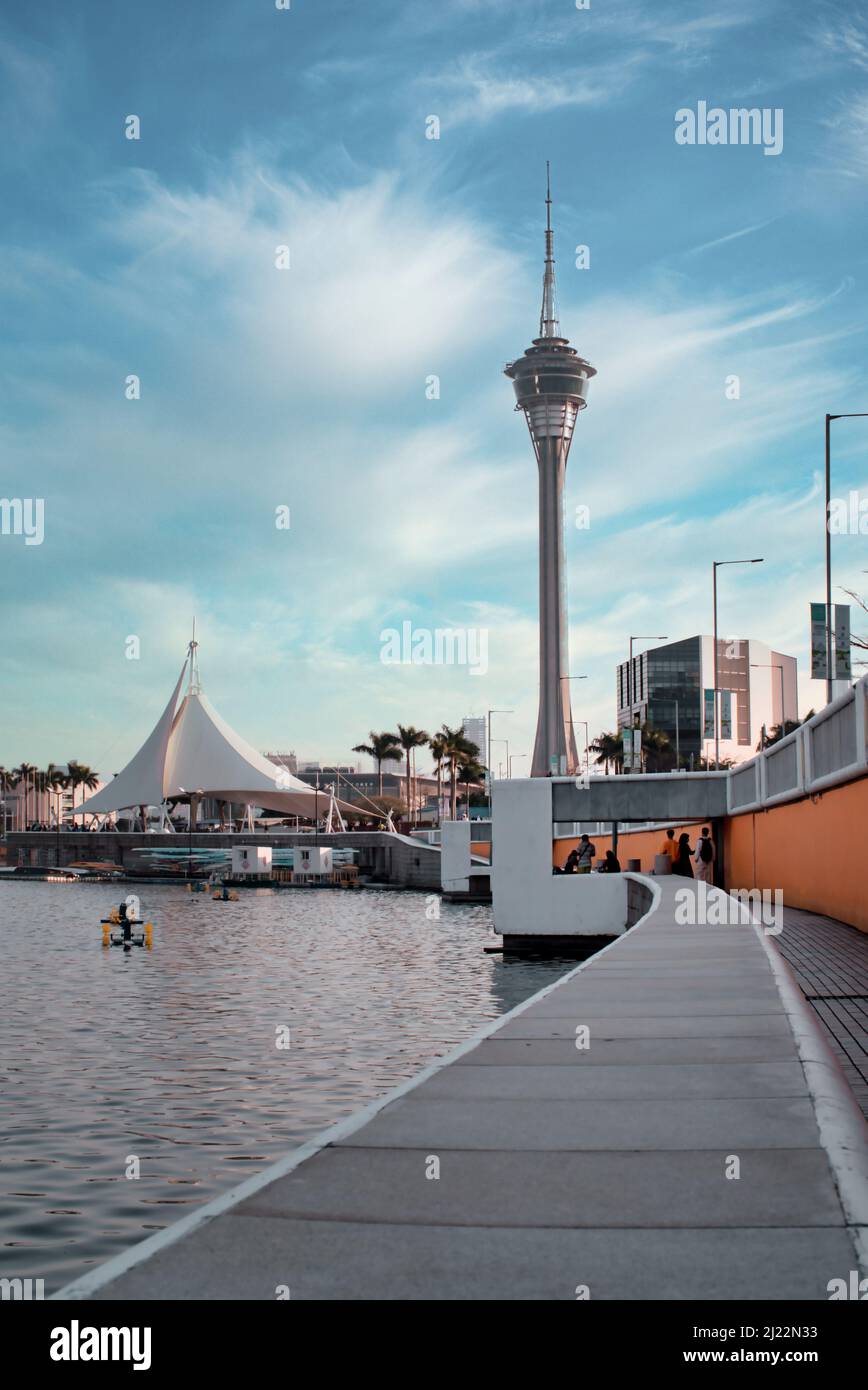 A vertical scenic view of the Macau tower in China by the sea against ...