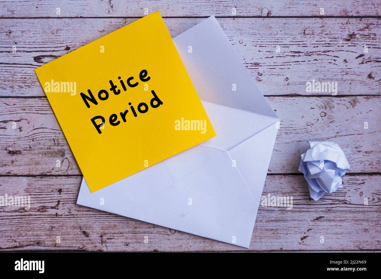 Notice period text on yellow notepad with envelope background ...