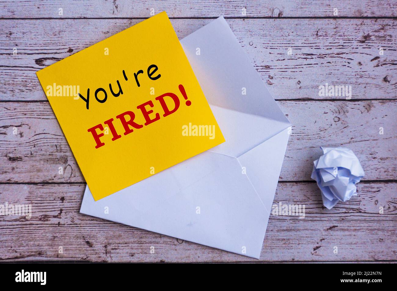 You are fired text on yellow notepad with envelope background ...