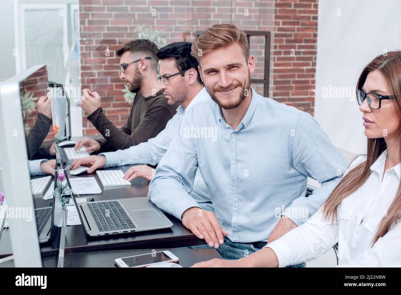 smiling employee of the business center in the workplace Stock Photo ...