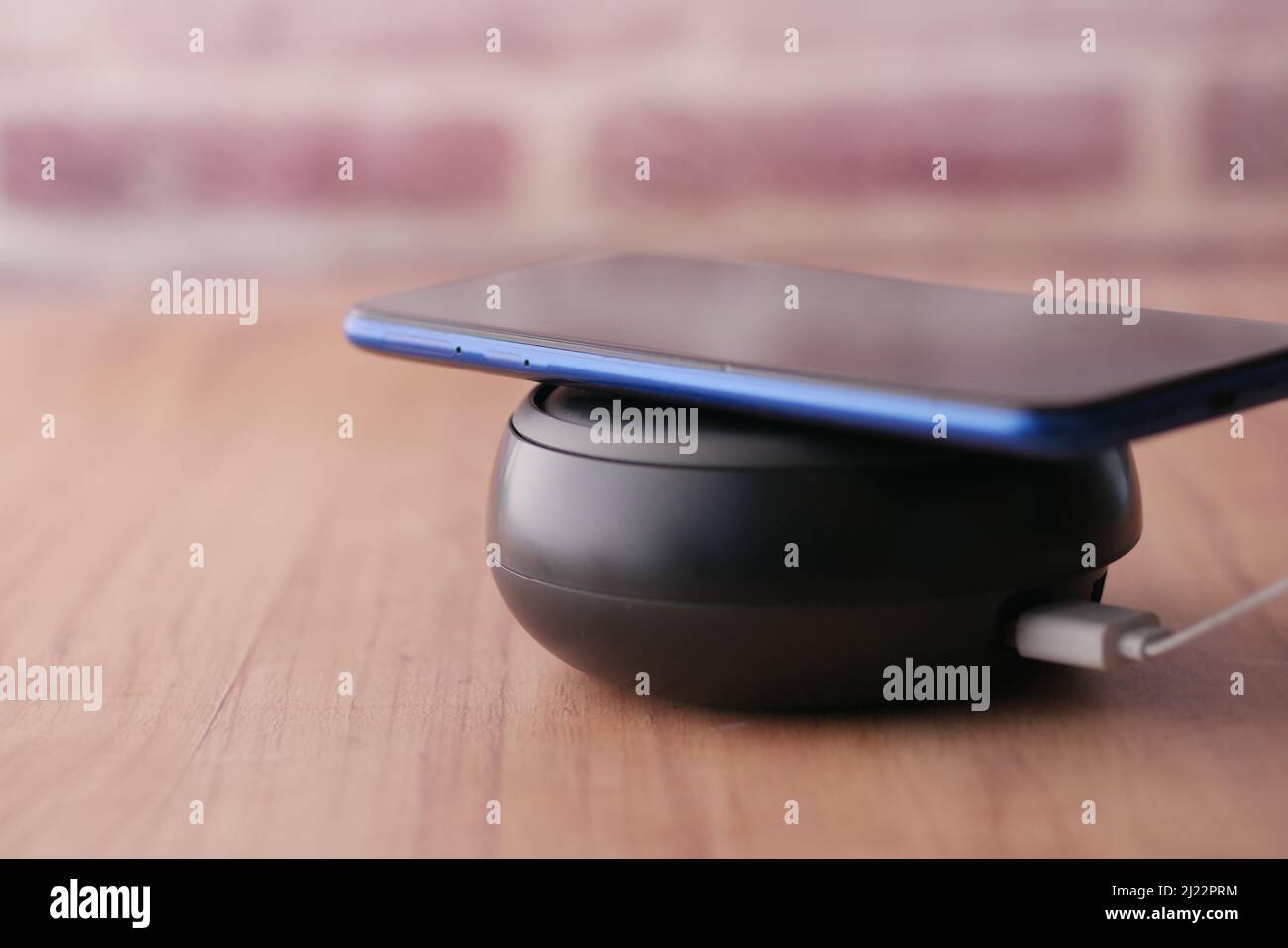 charging Smartphone using Wireless Charging Pad, top view Stock Photo ...