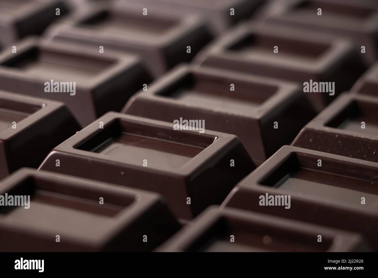 Close up a chocolate bar background. Chocolate bar cubes macro Stock ...