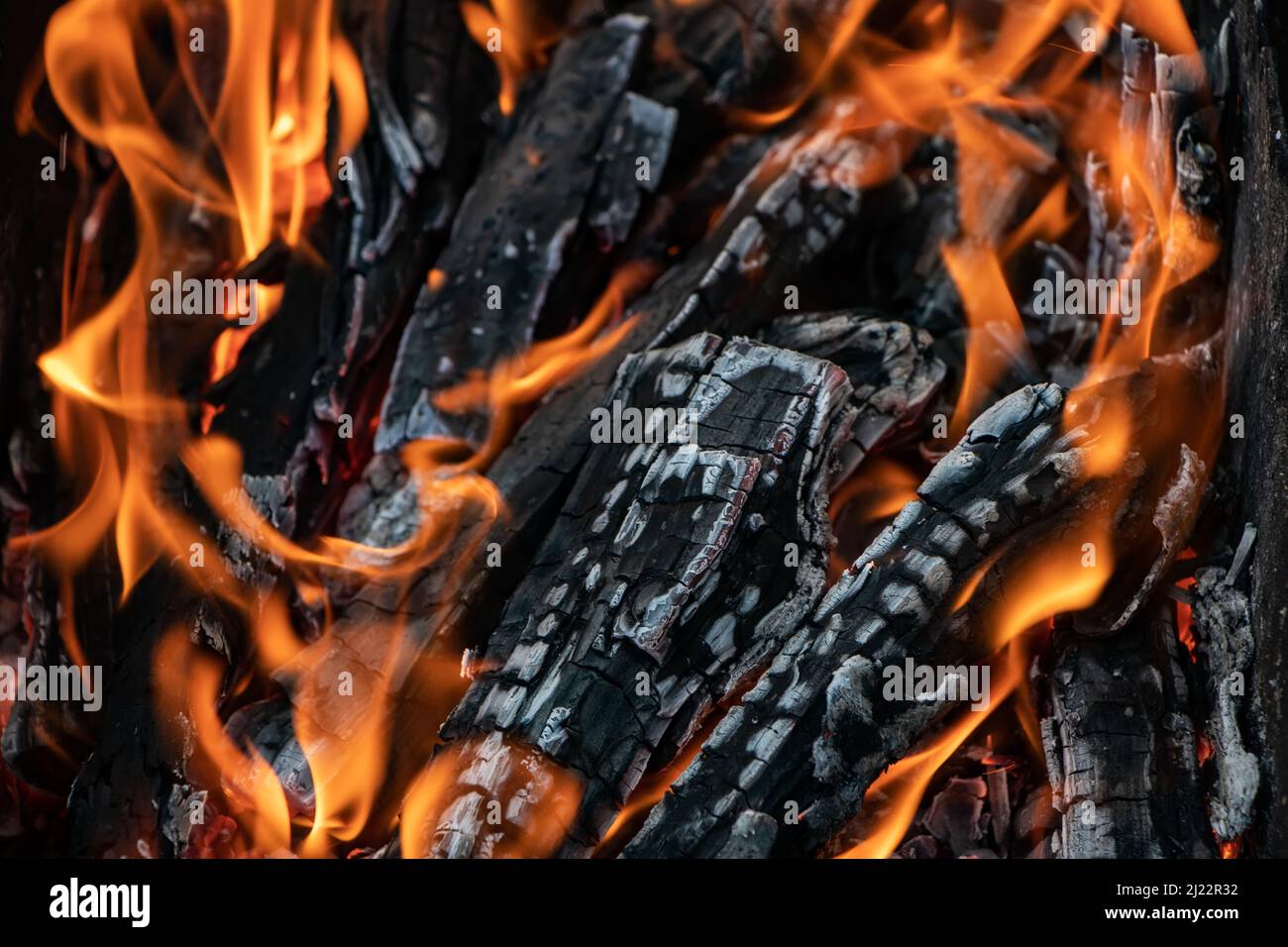 Glowing embers in hot red color, abstract background. The hot embers of ...