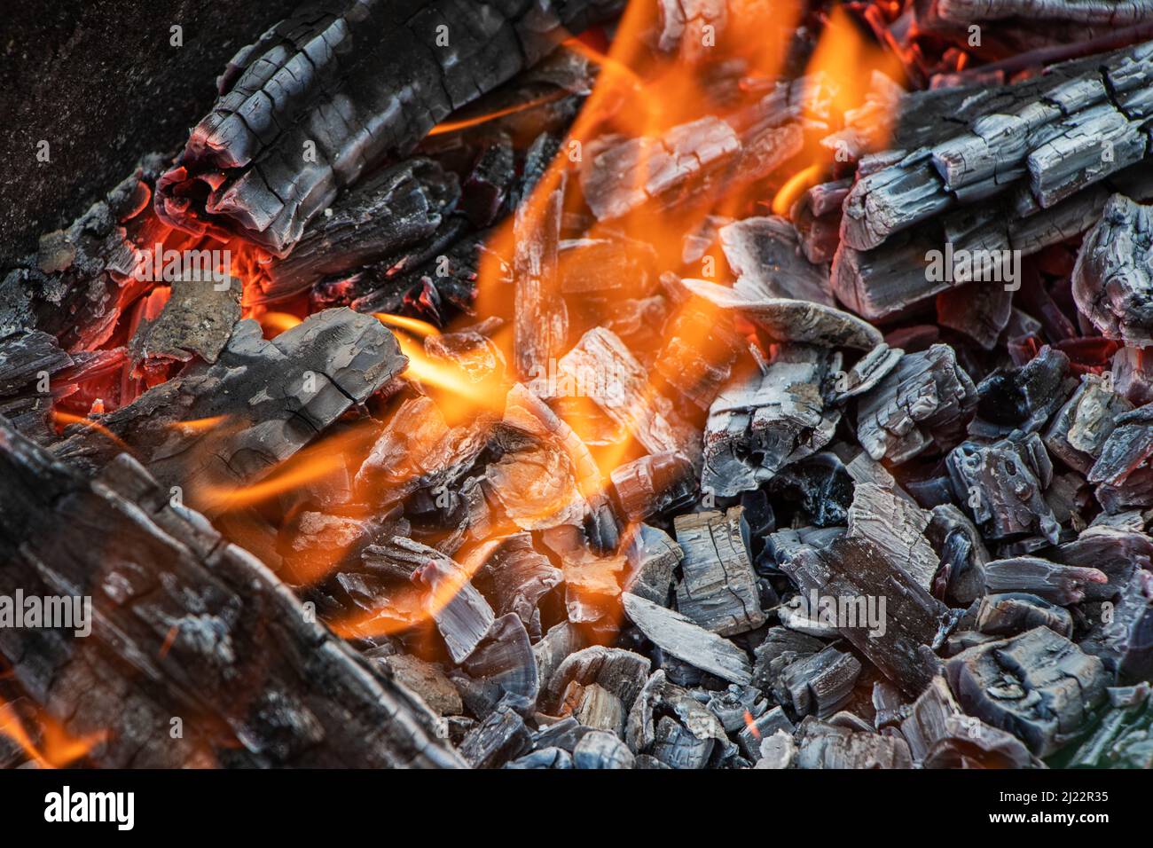 Glowing embers in hot red color, abstract background. The hot embers of ...