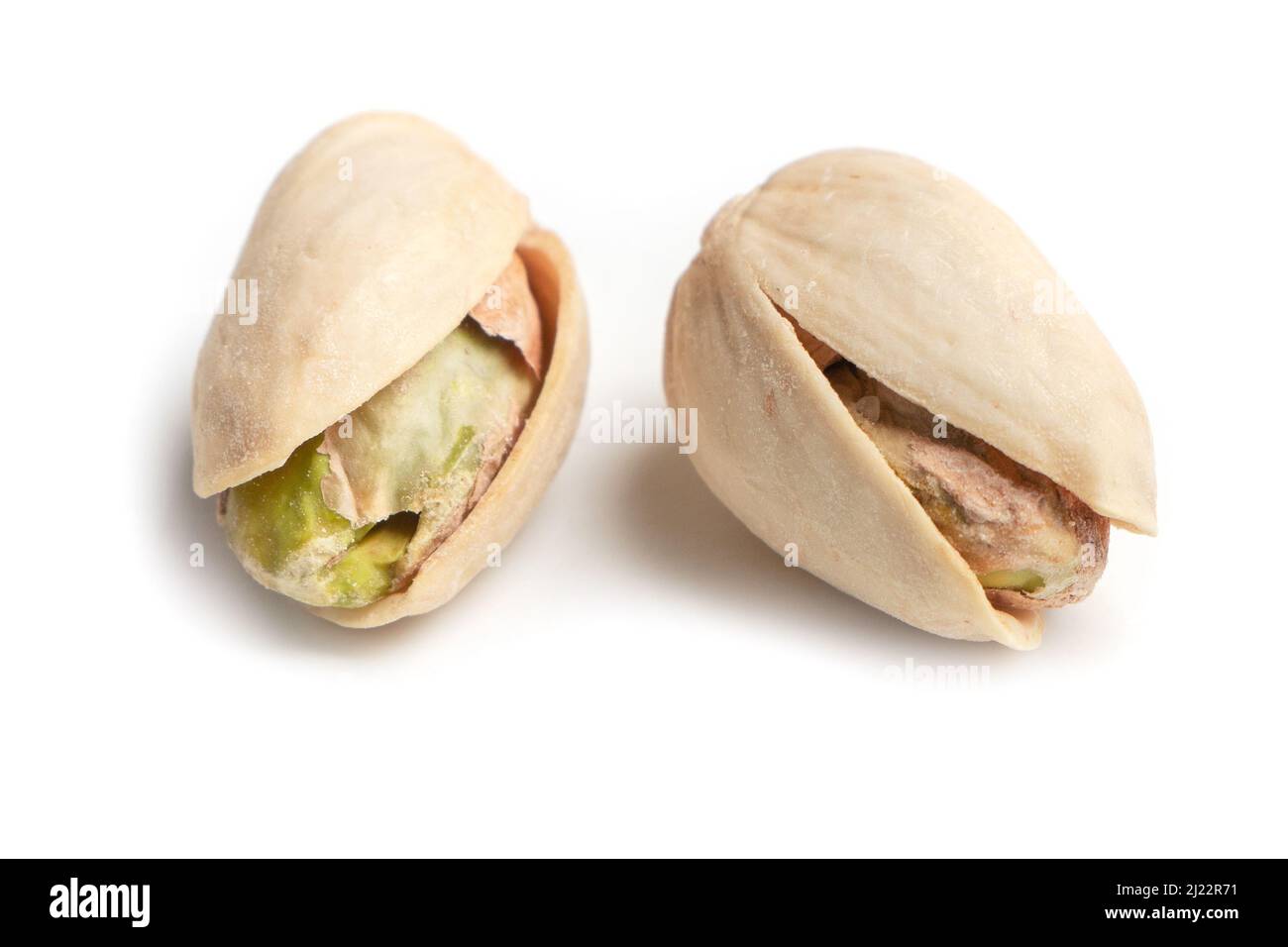 Peeled and unpeeled pistachios on isolated background for package or ...