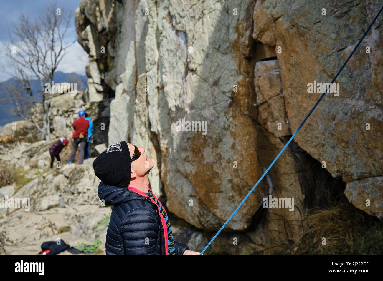 A Happy Male climber standing near cliff Stock Photo - Alamy
