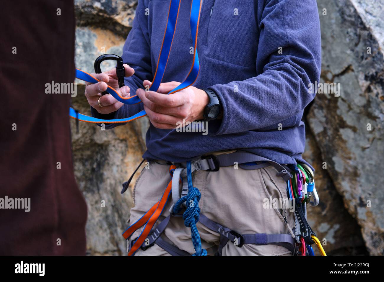 Rock climbing instructor is teaching how to perform the belay station ...