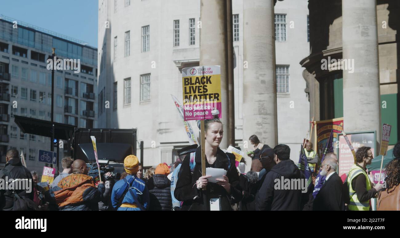 London, UK - 03 19 2022: A woman protester walking at Portland Place ...