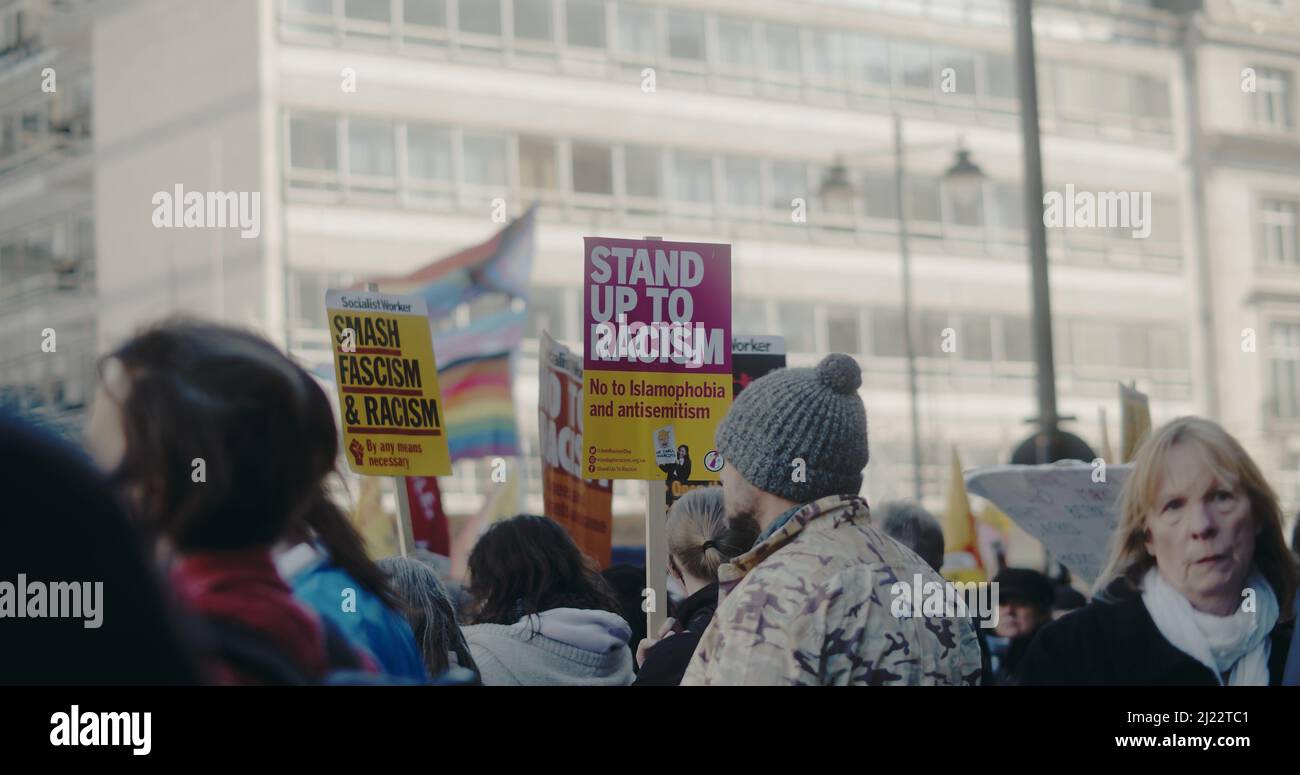 London, UK - 03 19 2022: Woman protester holding a sign, ‘Stand Up To ...