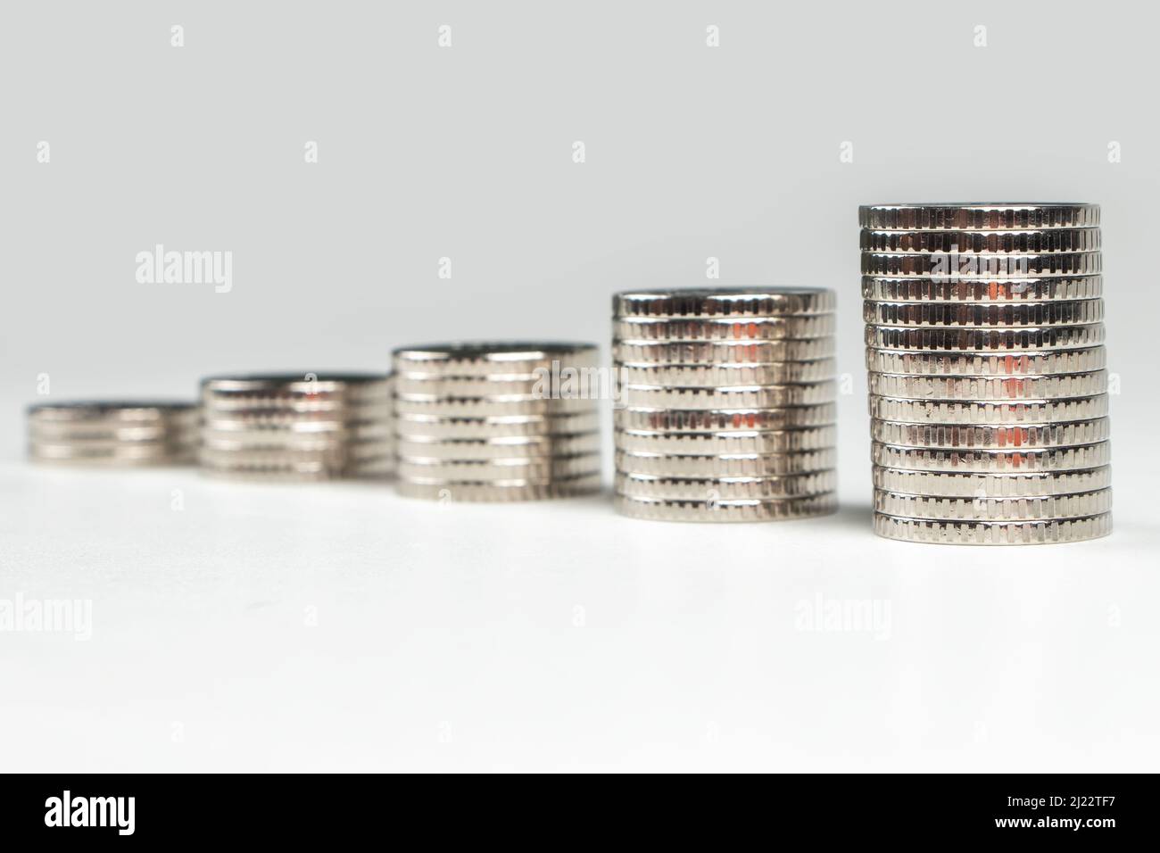 Stack of silver coins isolated on white background Stock Photo - Alamy