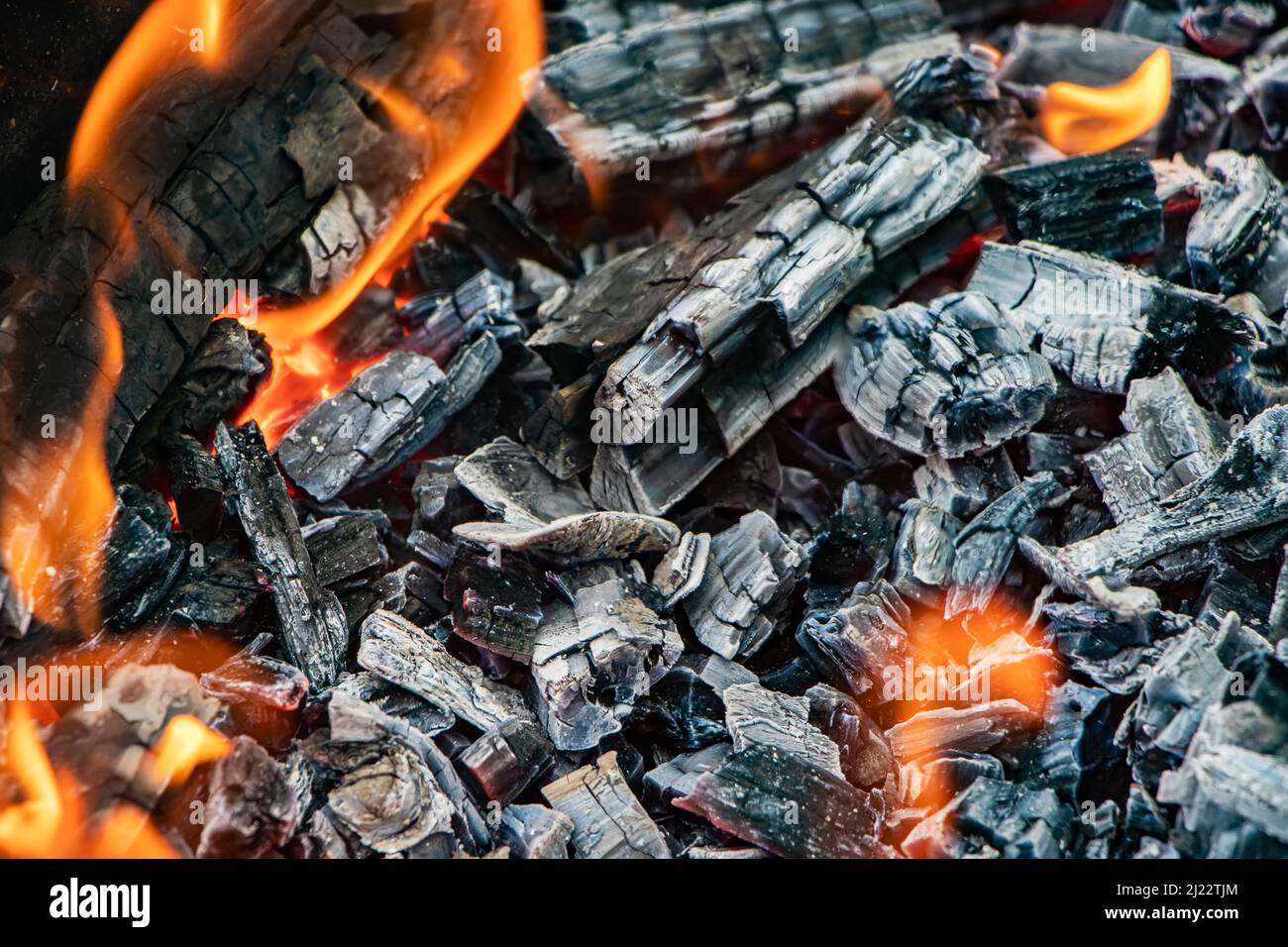 Glowing embers in hot red color, abstract background. The hot embers of ...