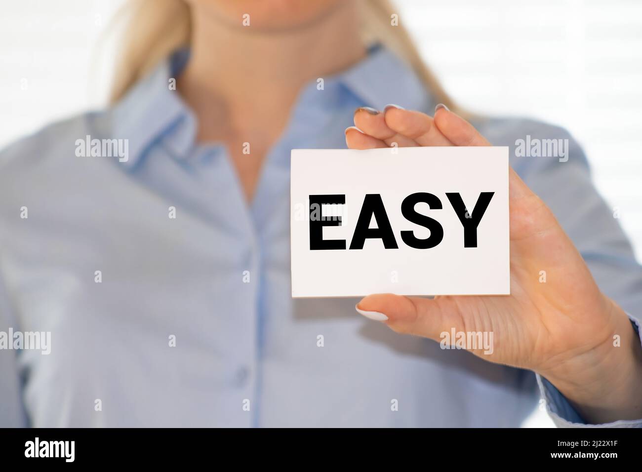 EASY message on the card shown by a man, vintage tone Stock Photo - Alamy