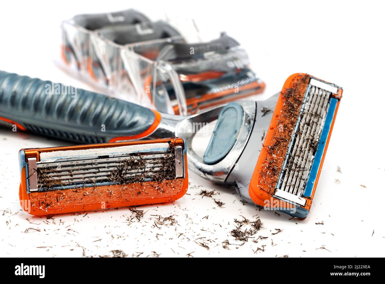 Shaving machine on a white background. Used razor blades with hair ...