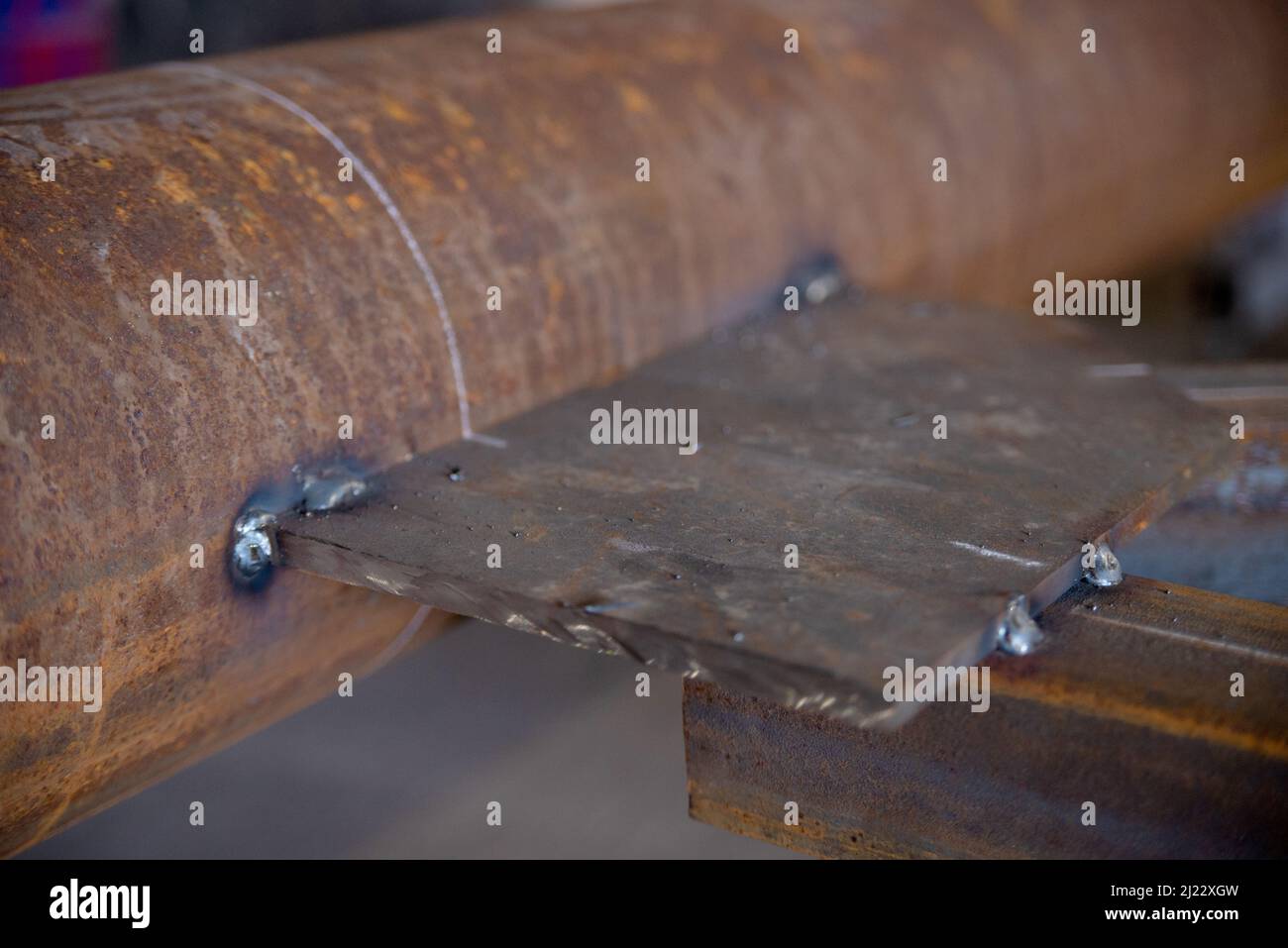 Welded butt joint. Rusty brown metal pipe steel plate welded together ...