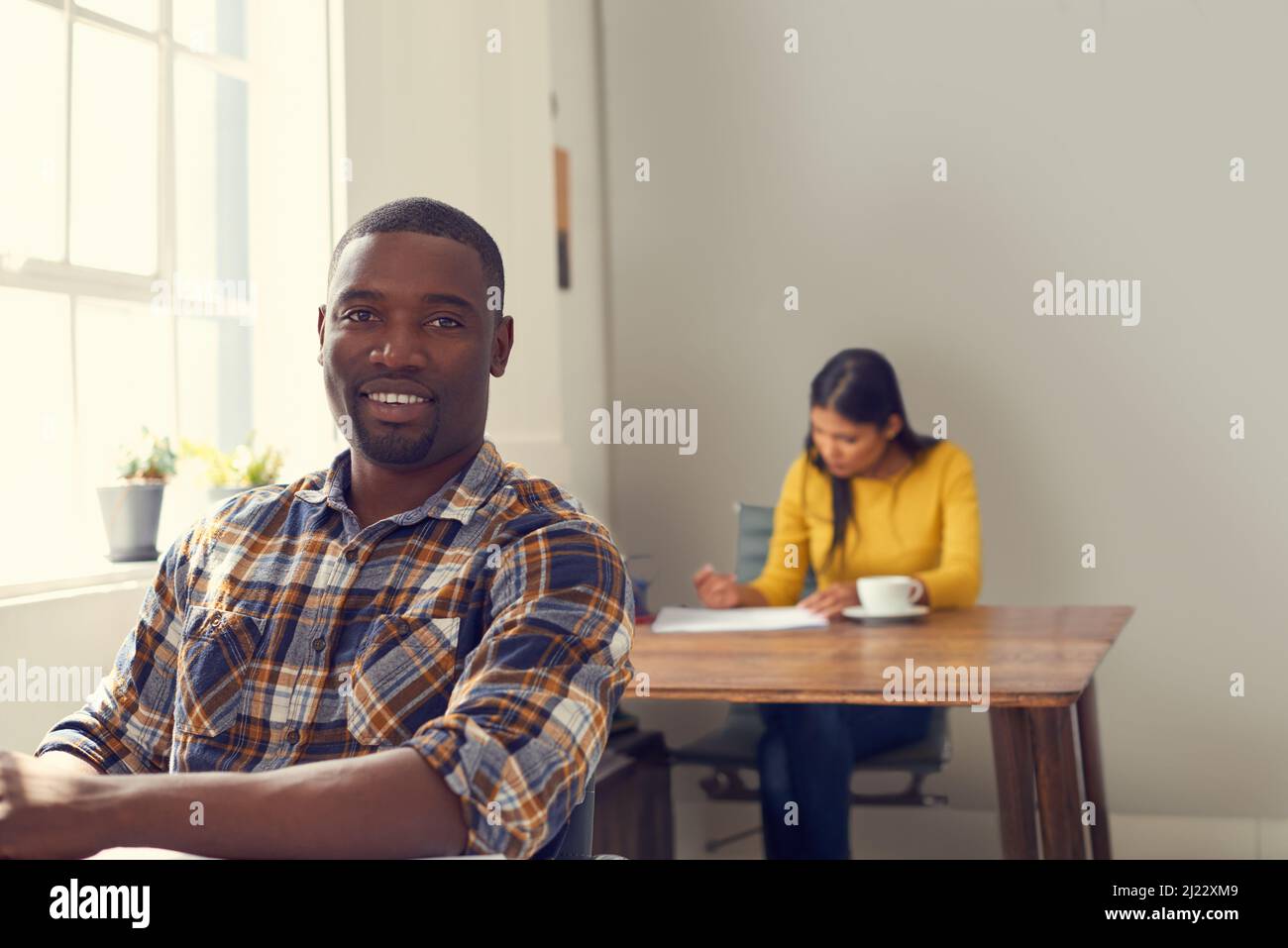 Small office but big on productivity. Shot of a young businessman ...