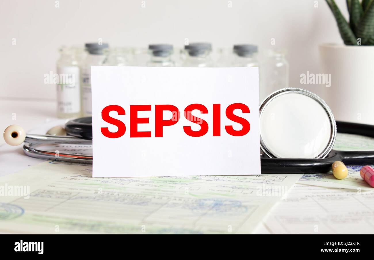 Doctor holding a card with text Sepsis, medical concept Stock Photo - Alamy