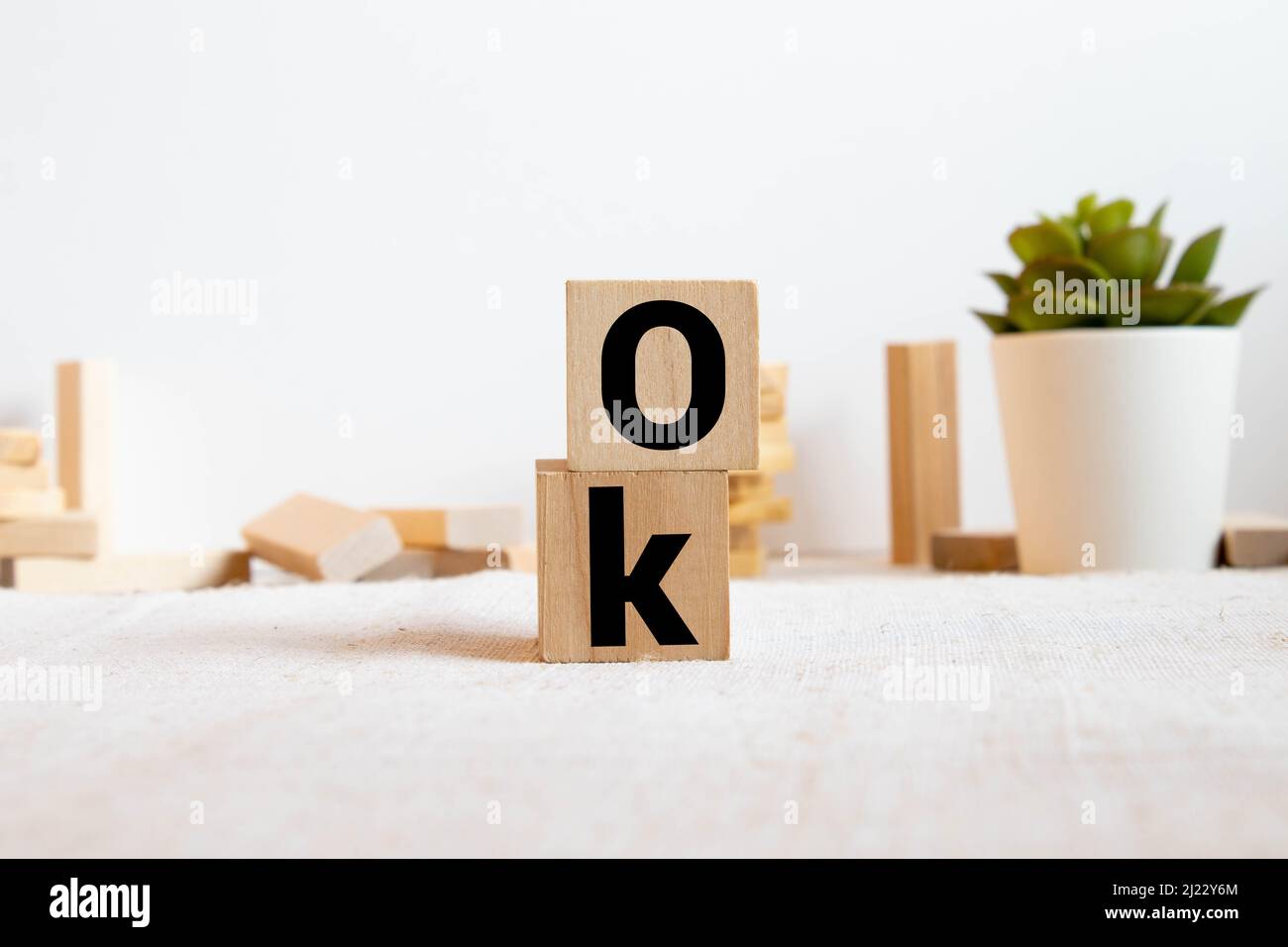 Word OK made with building blocks on white background with reflection ...