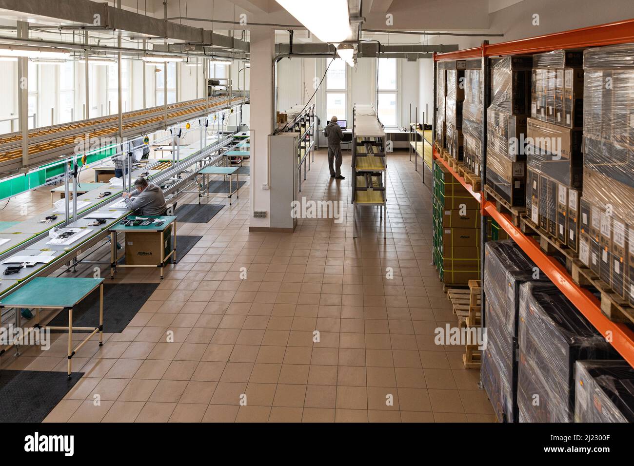 Photo of a plant for assembling monoblocks for computers. Working men ...