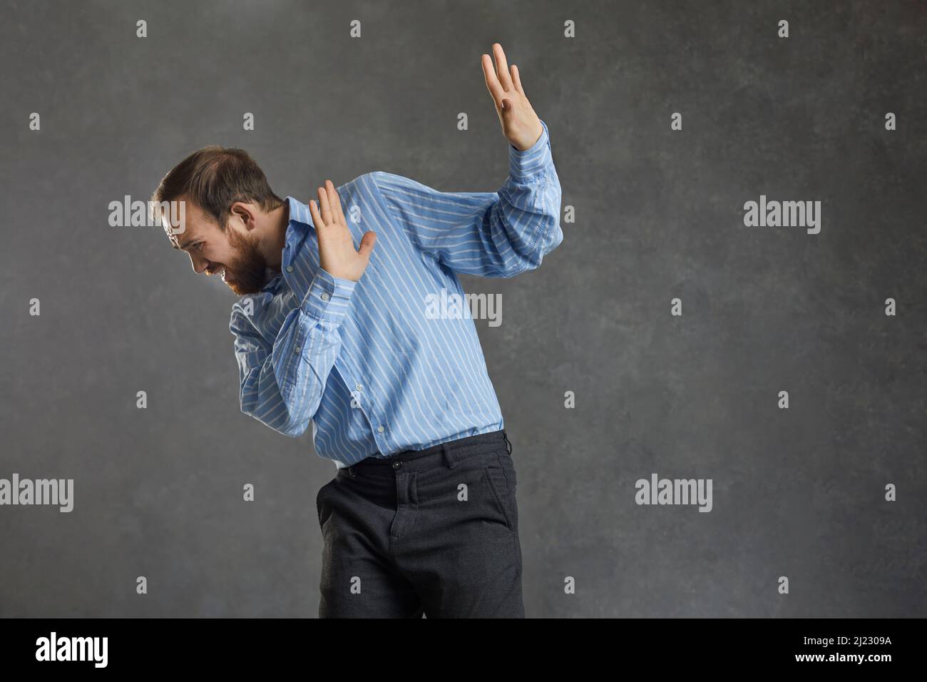 Nervous frightened caucasian man closes in horror waving his arms on a ...