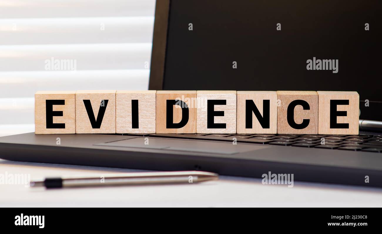 evidence word written on wood block. evidence text on table, concept ...
