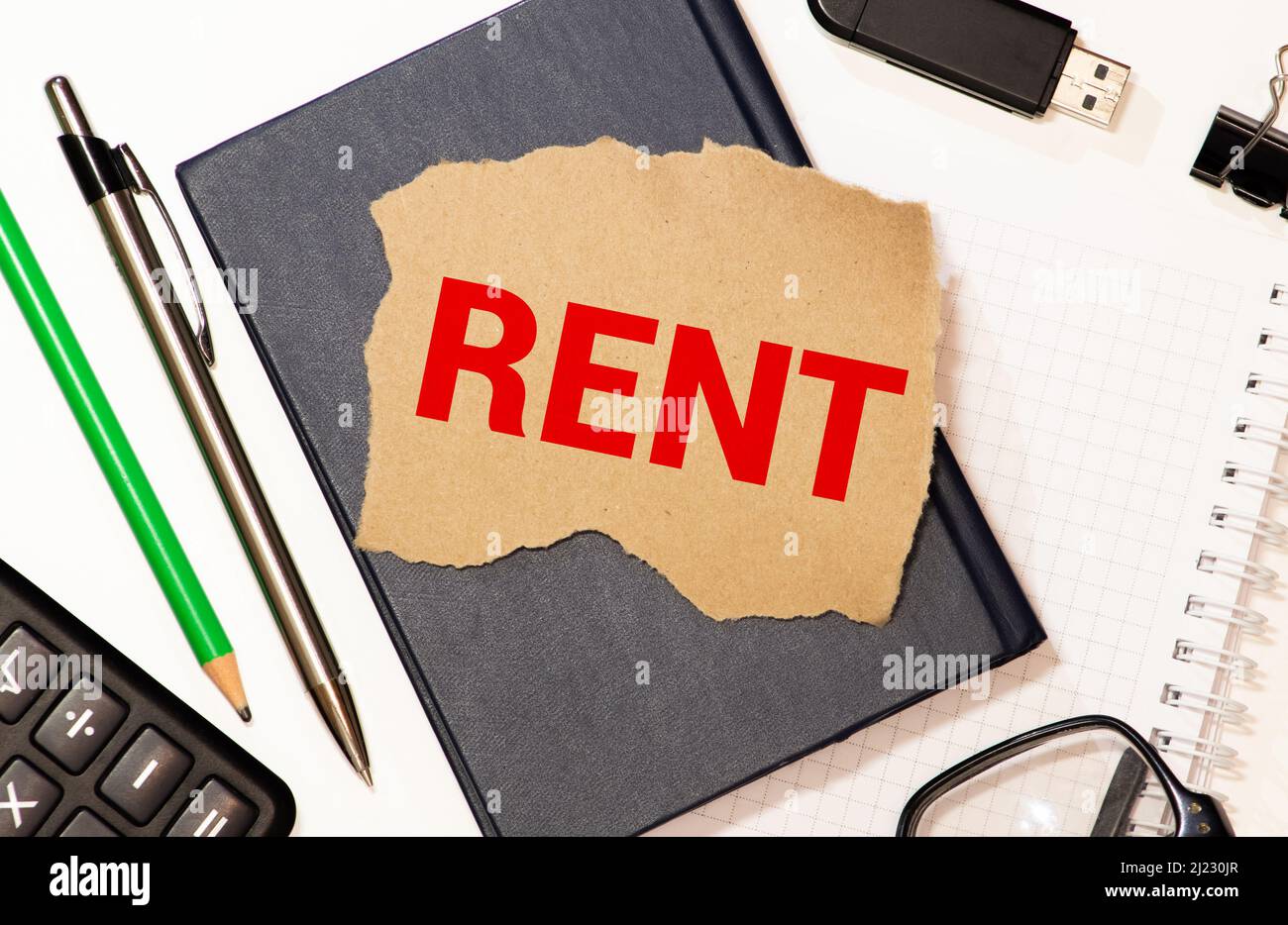 RENT text on paper on the chart background with pen Stock Photo - Alamy