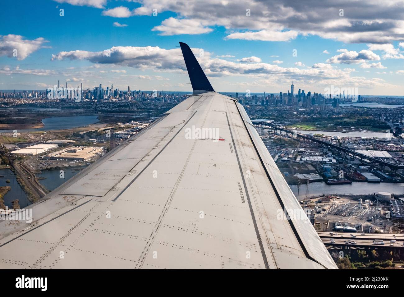 A wing of the airplane flying over New York city, USA Stock Photo - Alamy