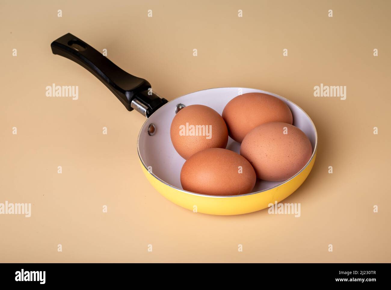 Eggs in pan on beige background. Easter celebration tradition concept ...