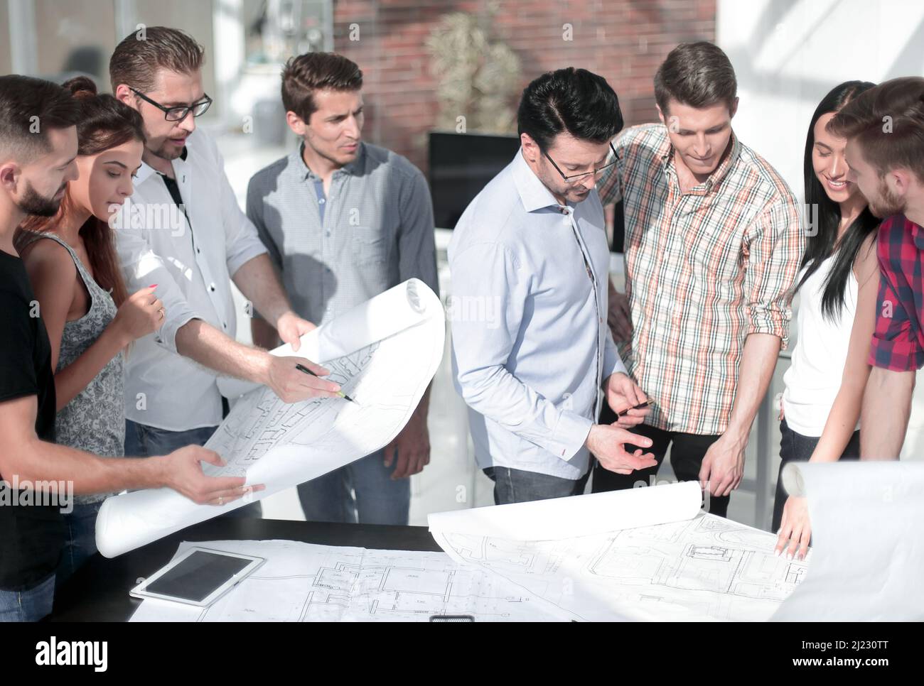 group of designers and architects discussing new sketches Stock Photo ...