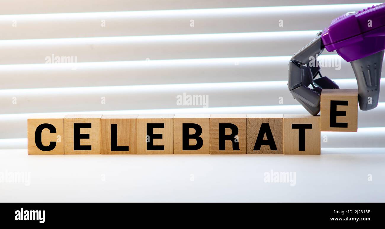 Celebrate word written on wood block. Celebrate text on cement table ...