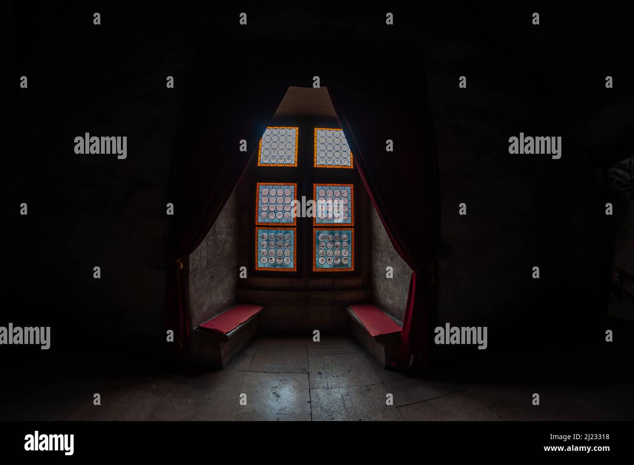 Beautiful design of a small window of a castle Stock Photo - Alamy