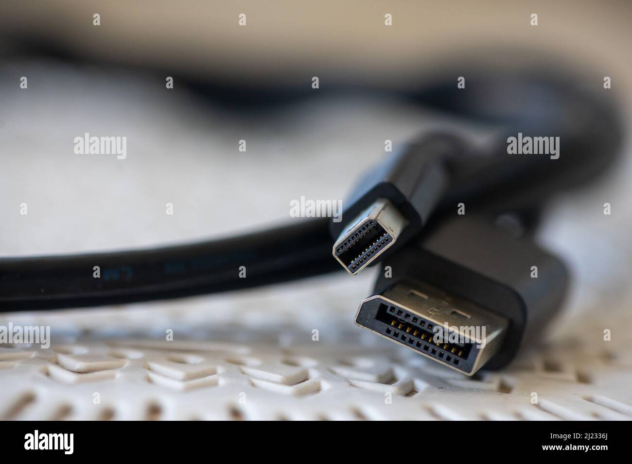 A mini direct port to direct port cable sitting on the table Stock ...