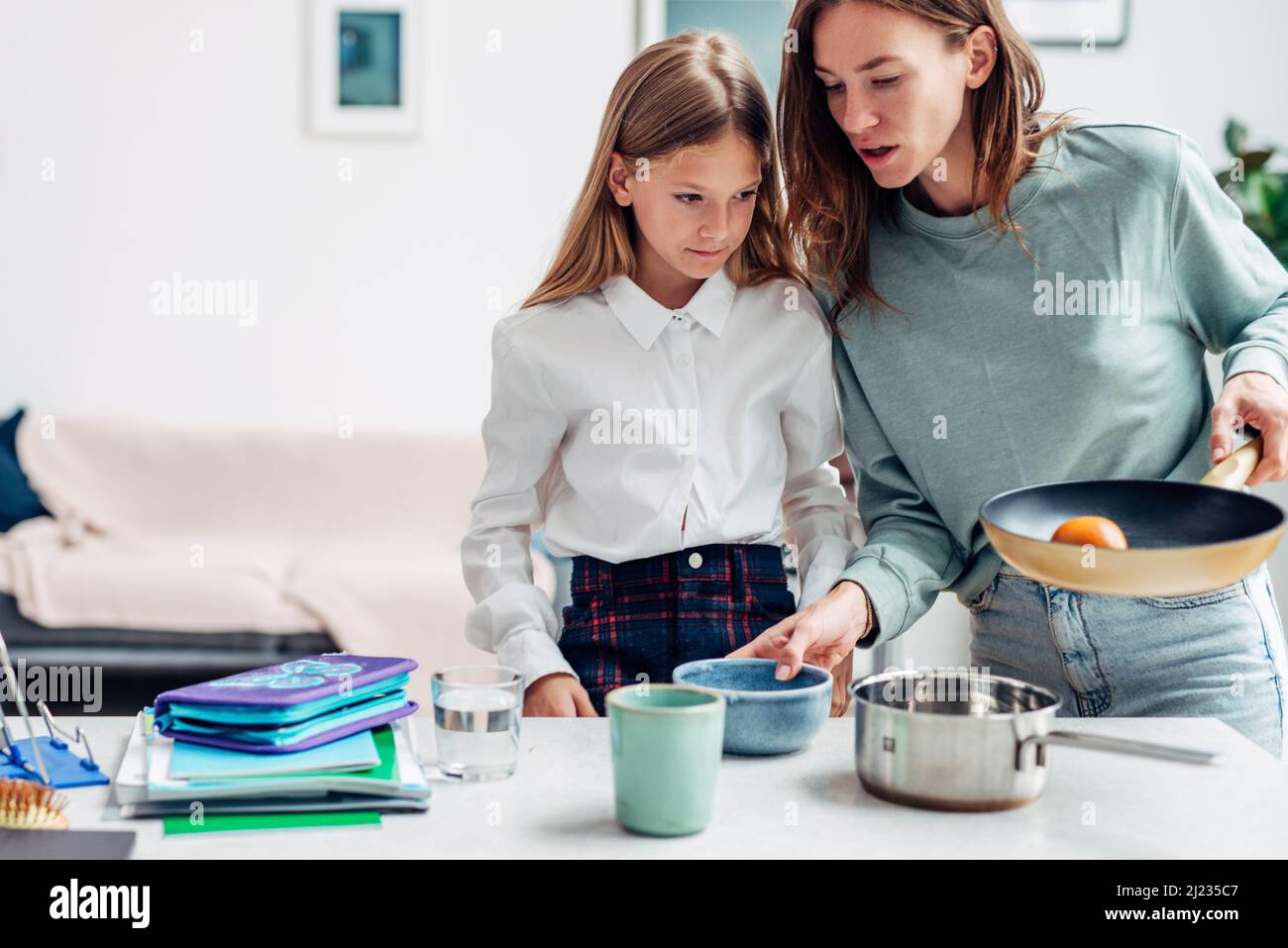 On the morning before school, mother and daughter at breakfast Stock ...